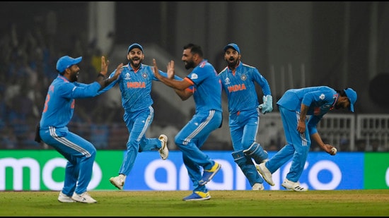 Indian cricket players celebrating on field